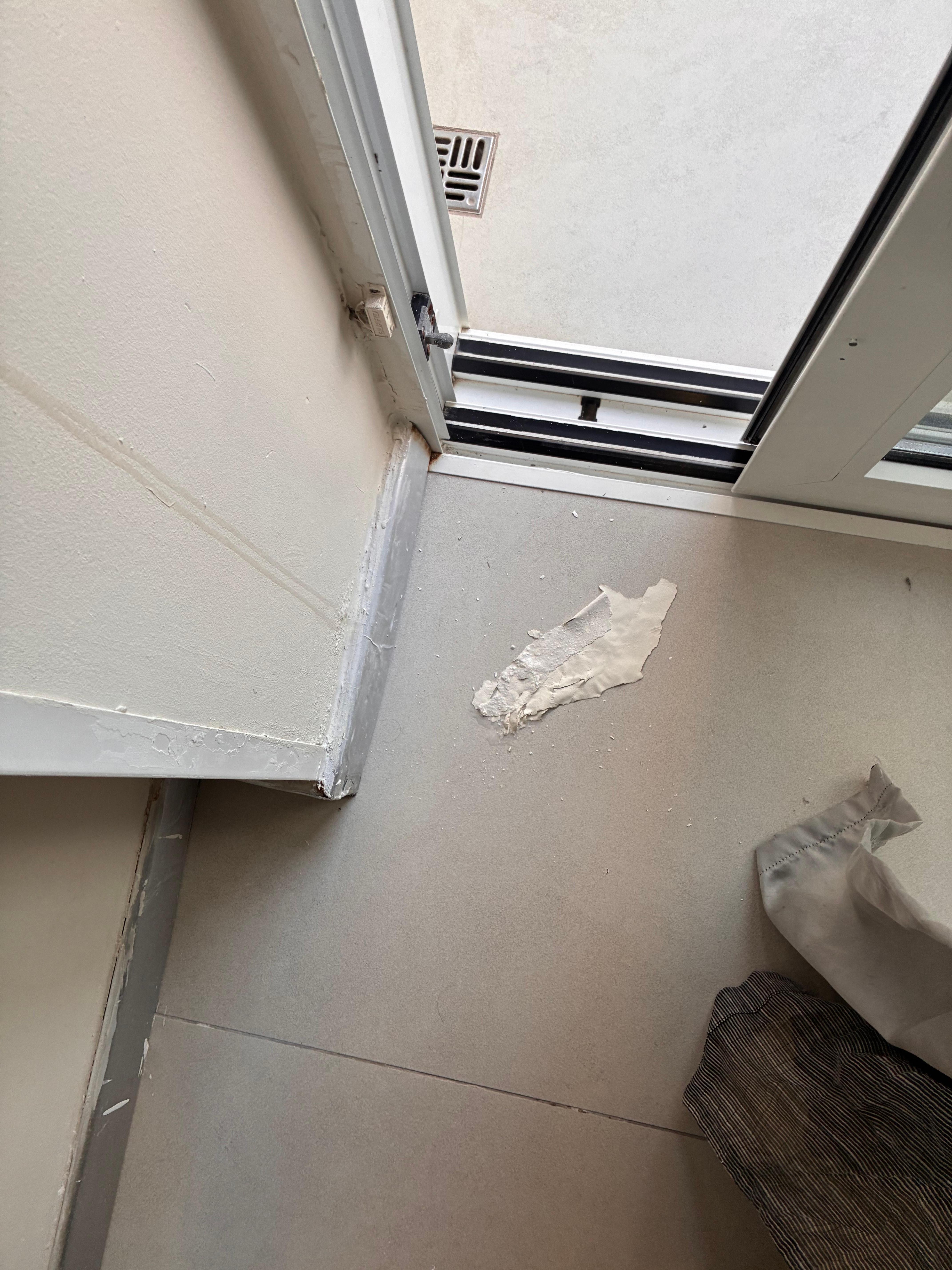 Paint falling from wet walls in the room. 