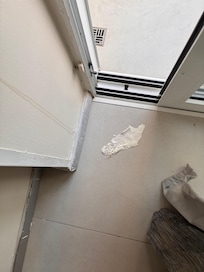 Paint falling from wet walls in the room.