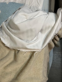 Frayed sheets on sleeper bed.