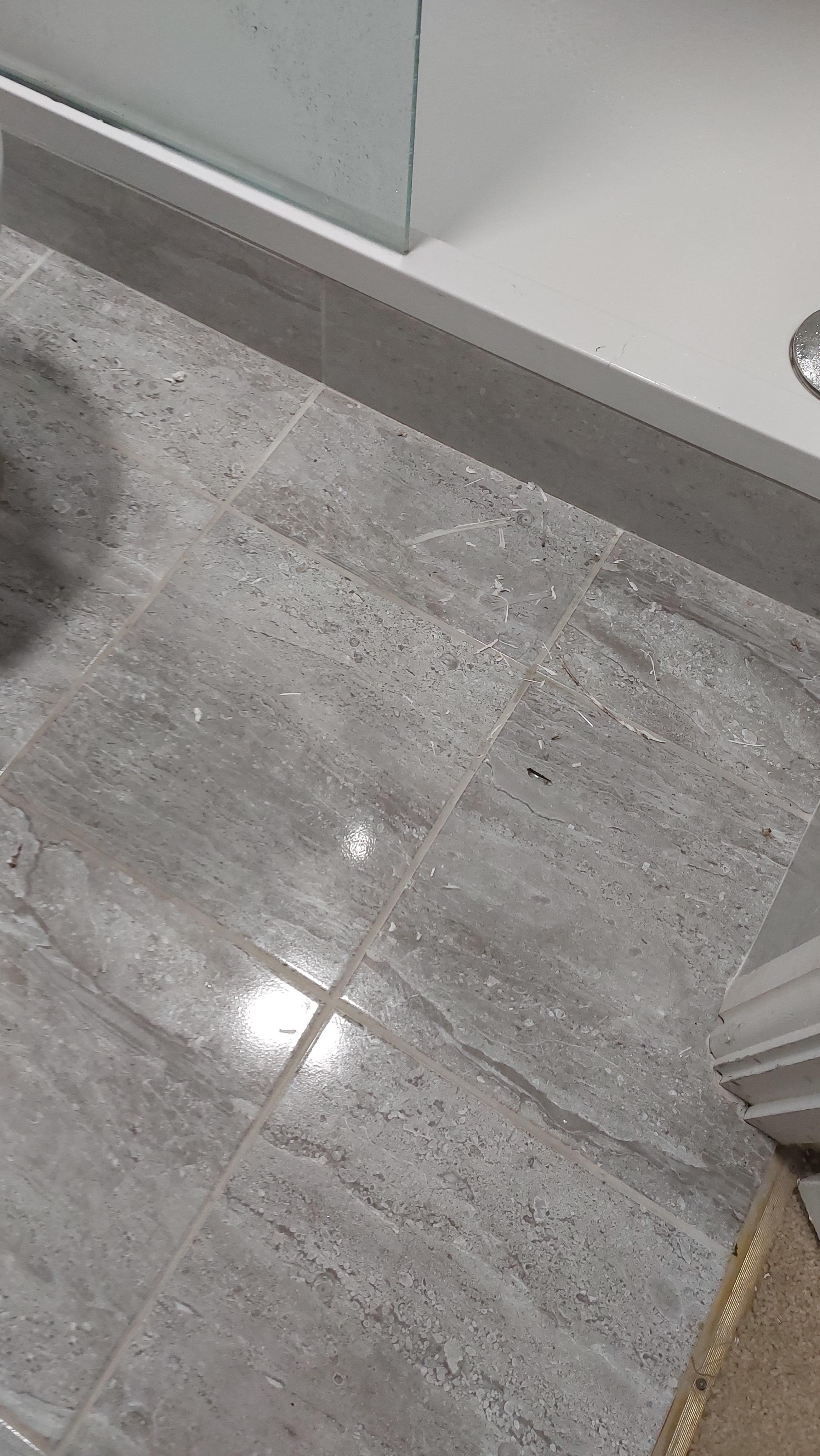 Silicone and hair all over bathroom floor 