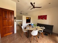 Living room with table & sofa looking towards King bedroom in back.