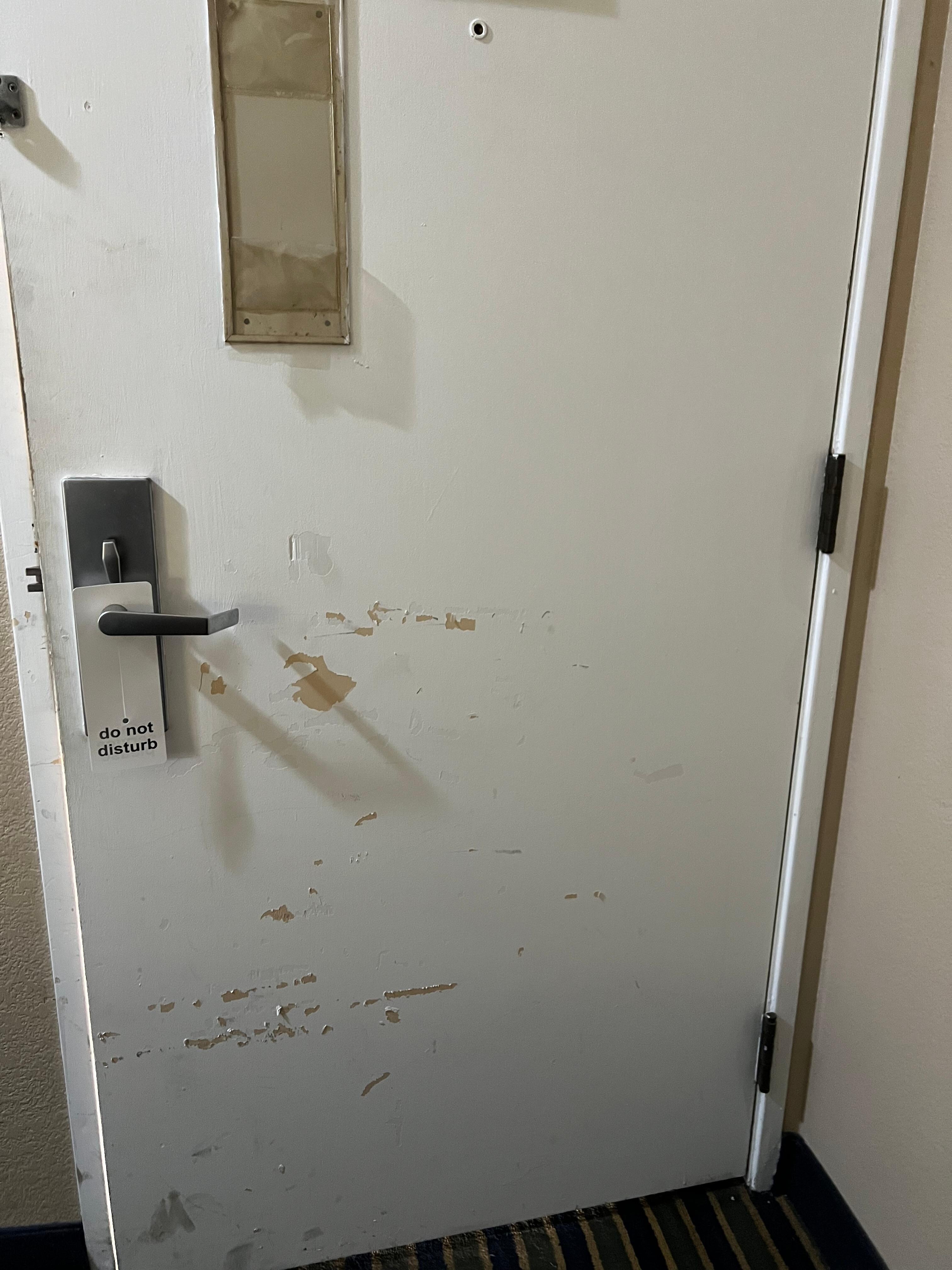 Damaged and dirty door room 242
