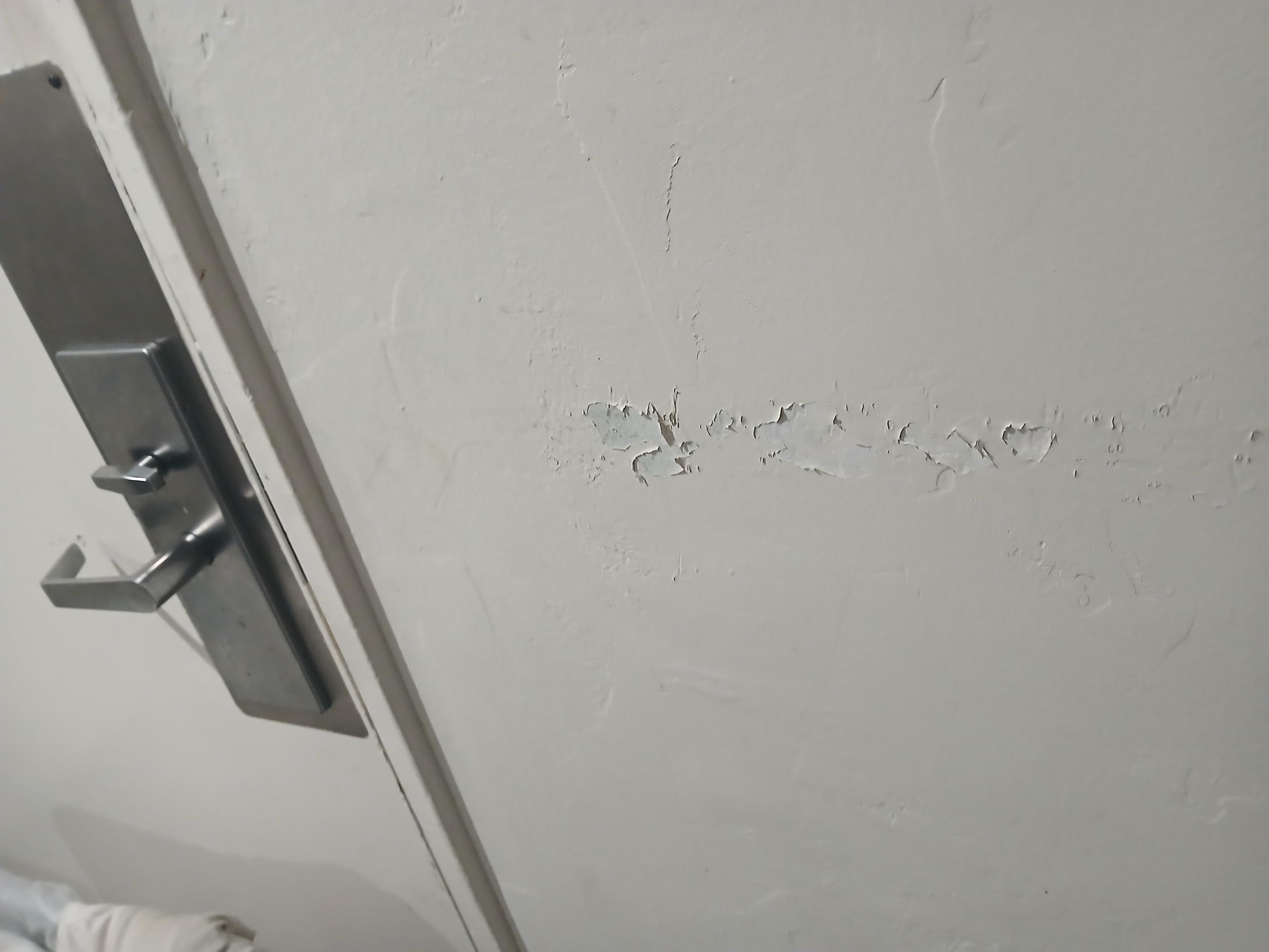 Paint peeling on wall inside room
