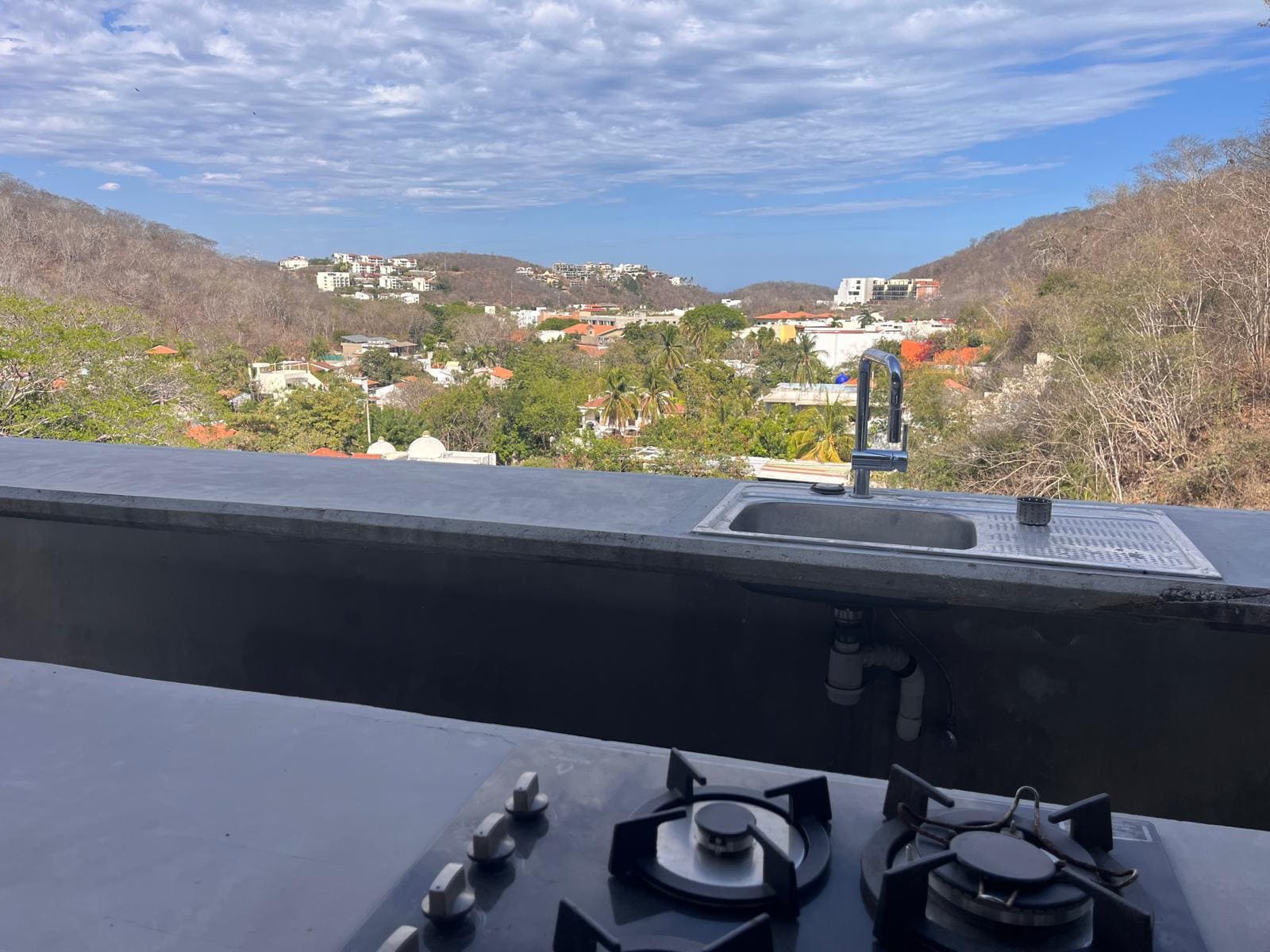 rooftop kitchen...  no gas line to cooktop.
cold water only at sink
BBQ is briquet only