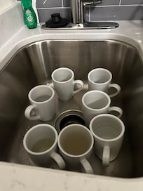 Coffee cups in kitchen sink never picked up