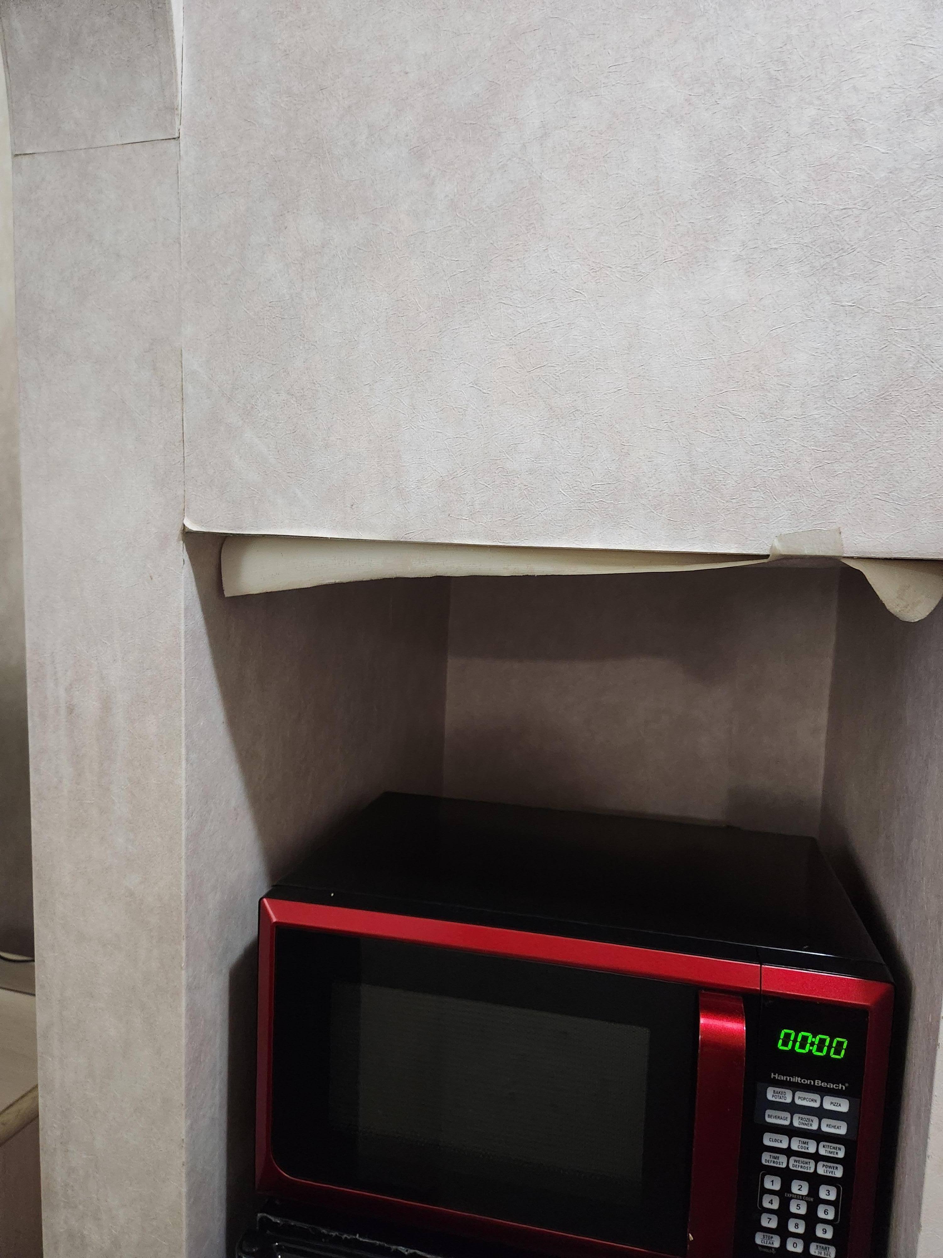 Peeling wallpapee above microwave