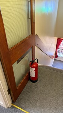 Extinguishers holding fire doors open. Disregard battery removed.