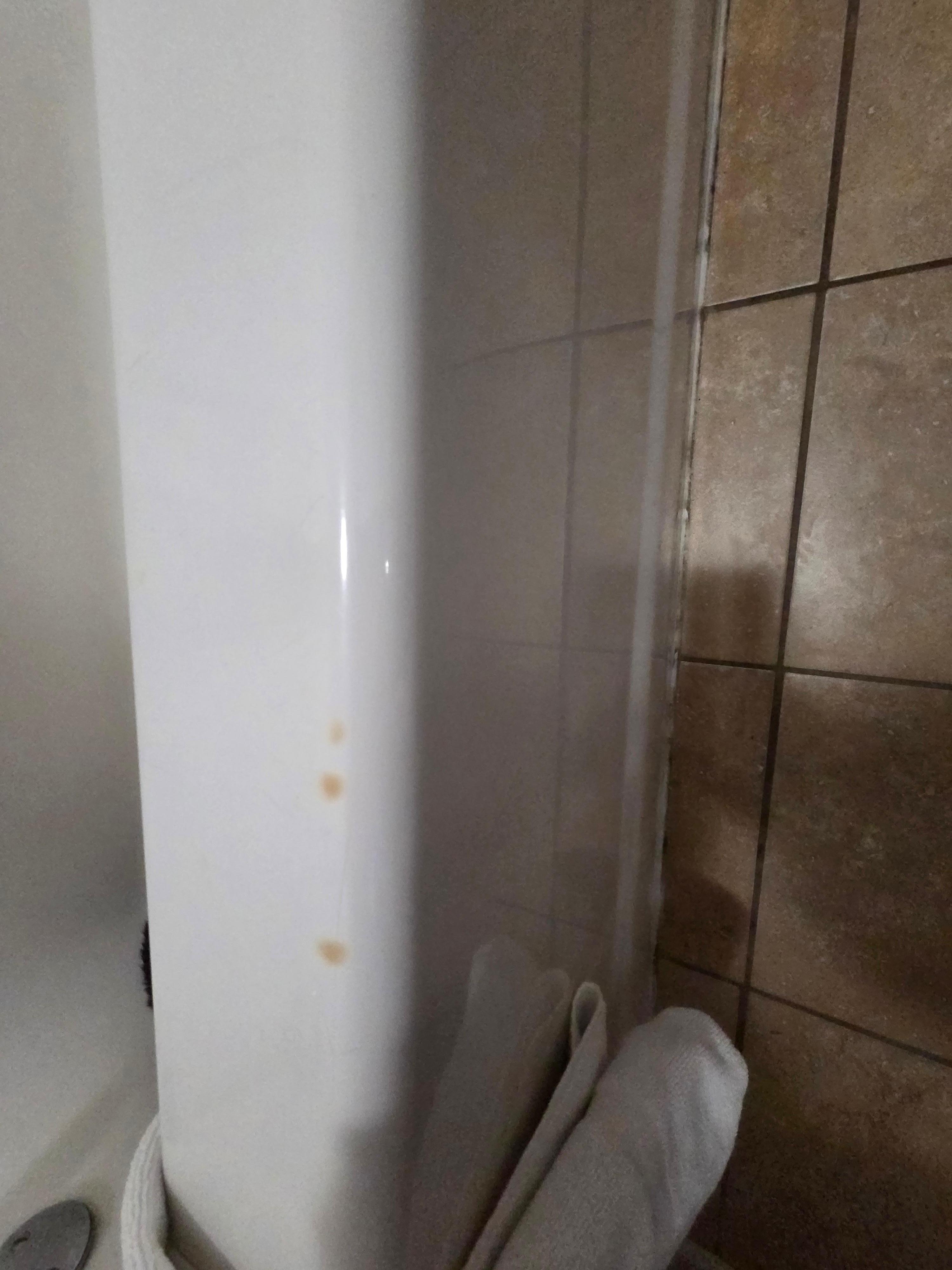 Nicotine marks on the bathtub where somebody set their cigarette