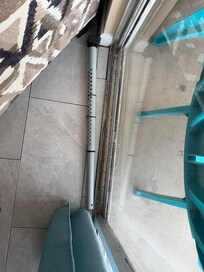 The pipe holding the balcony door closed