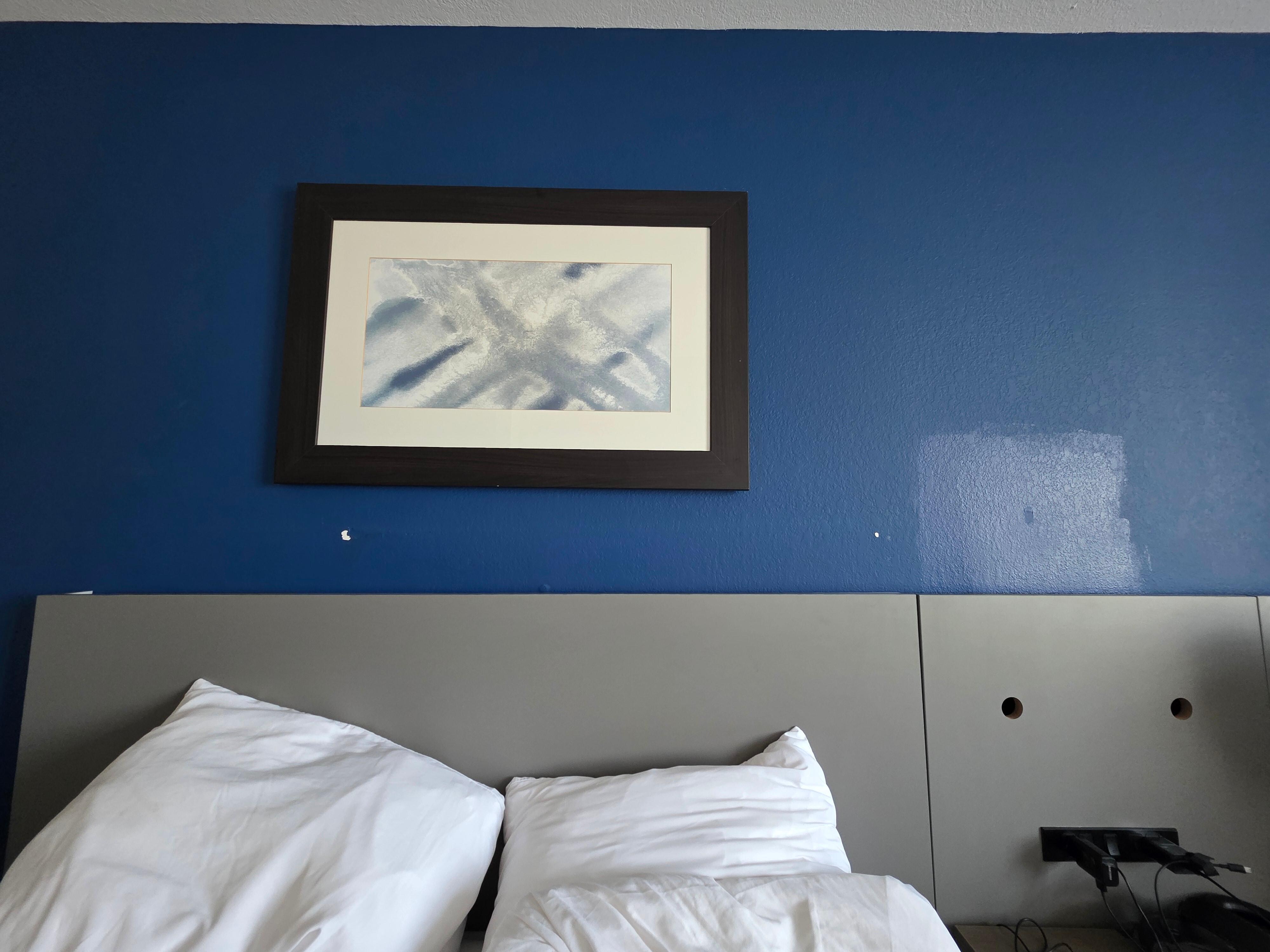 Holes where the bedside lamps should be. Not sure what's going on with the paint.