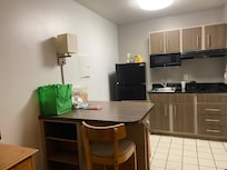 Nice large refrigerator and also a microwave, toaster and sink.
