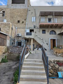 Uri Buri restaurant to the right, black sign and steps in this photo.