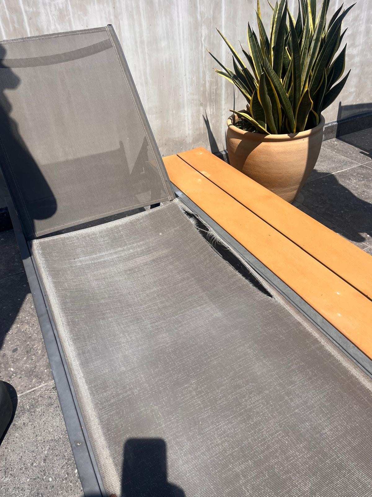 ripped chair on pool deck.  we set it aside so no one would use.. next day it was back in place