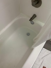 Photo of tub with standing water after shower