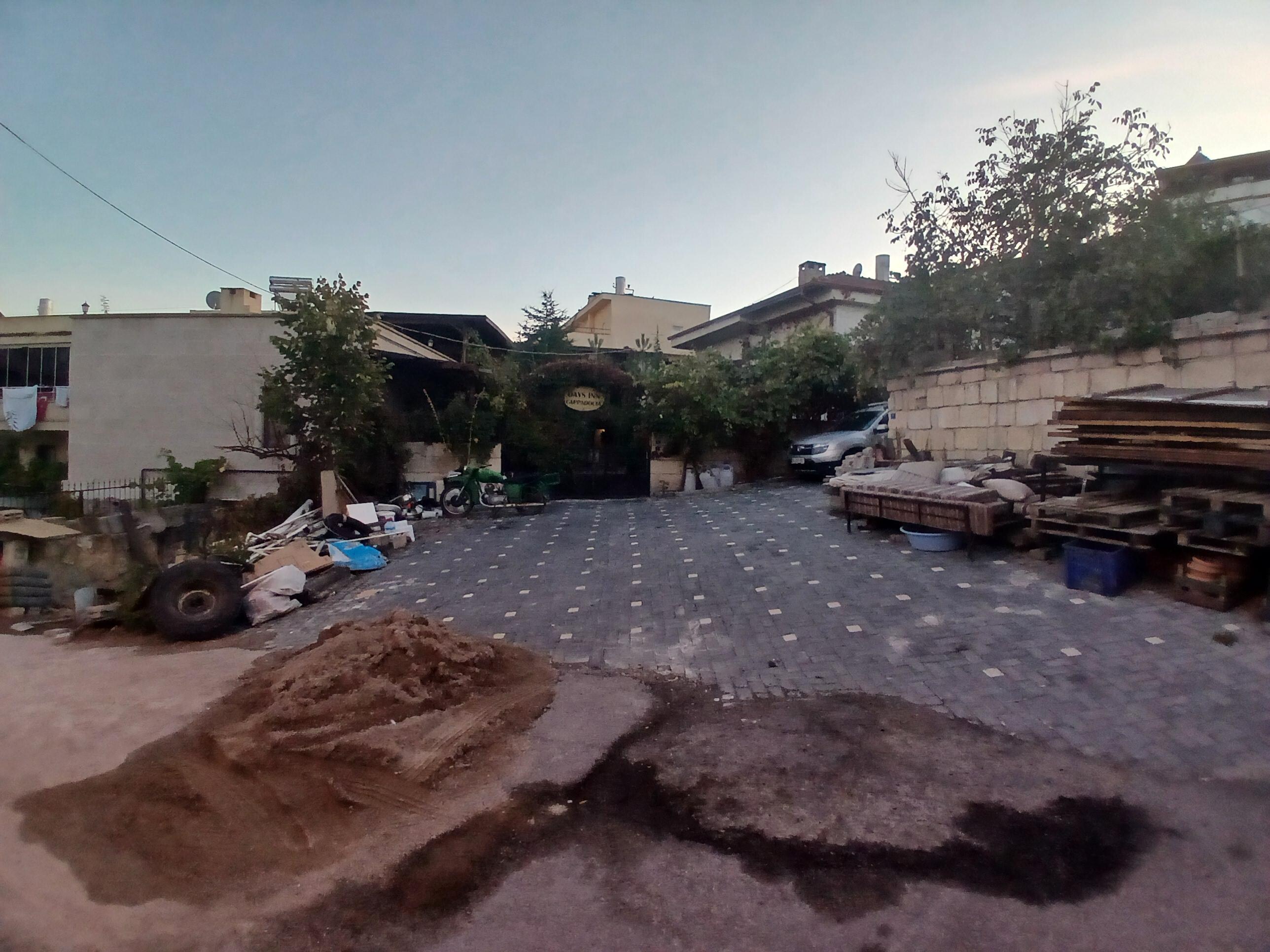 Construction material and load of gravel at entrance. 