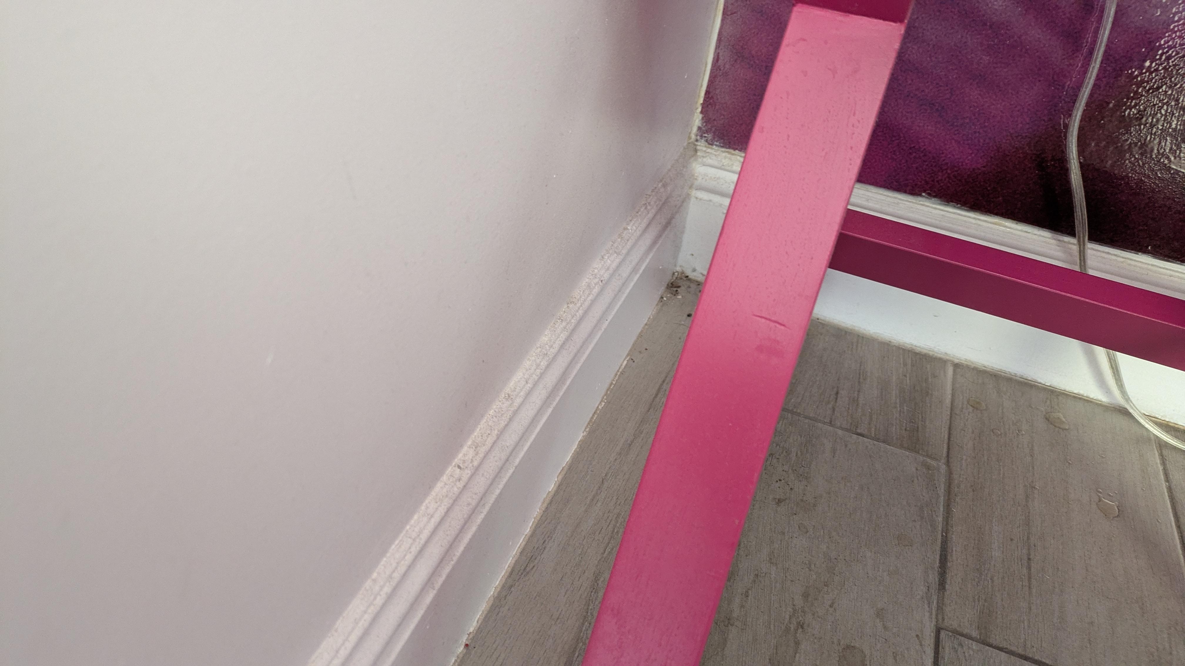 All the baseboards were covered with dust as well as the top of the headboard on the bed.