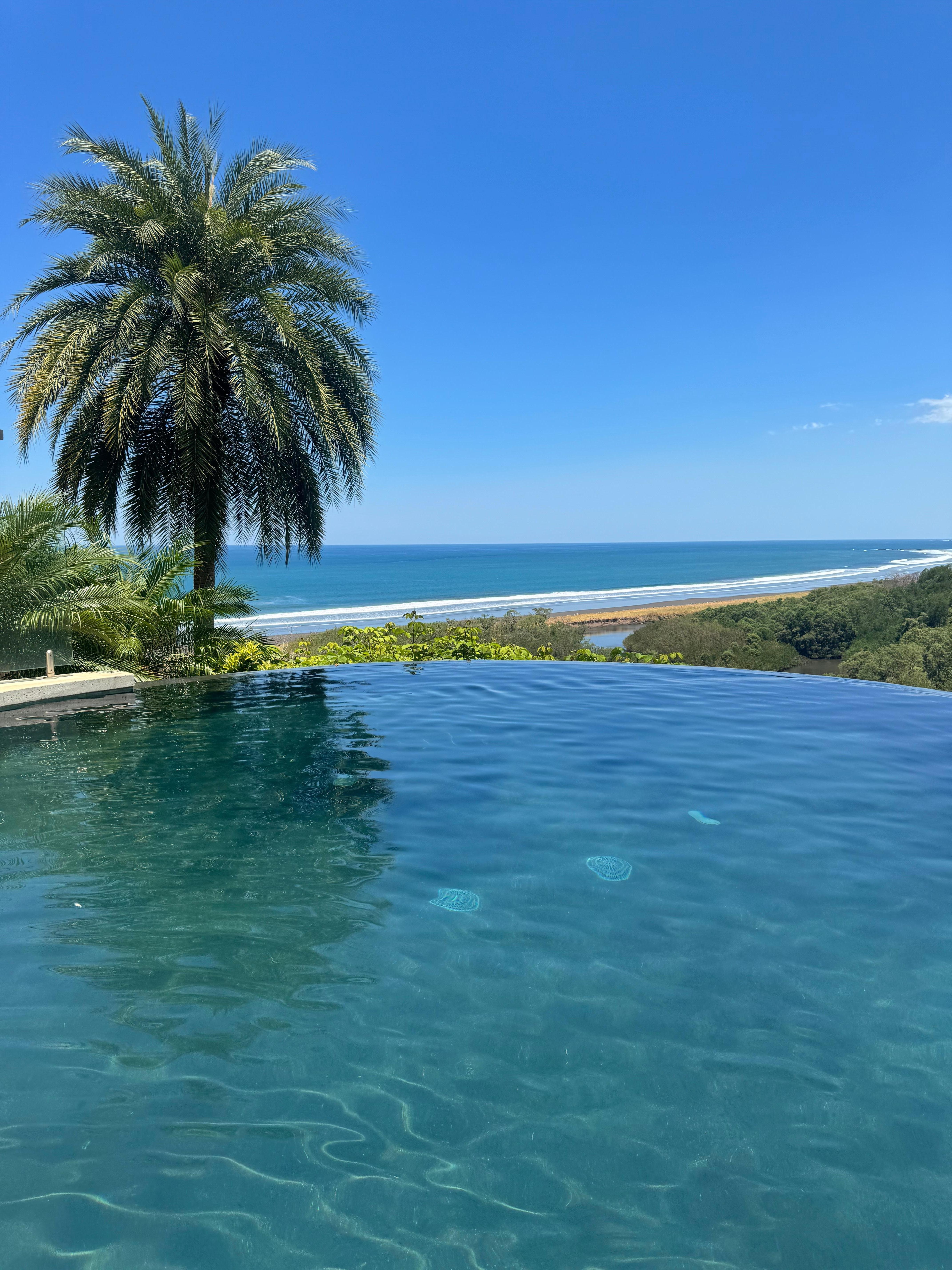 Main infinity pool w panoramic ocean and mountain views 