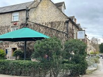 The front and Entrance near the green umbrella