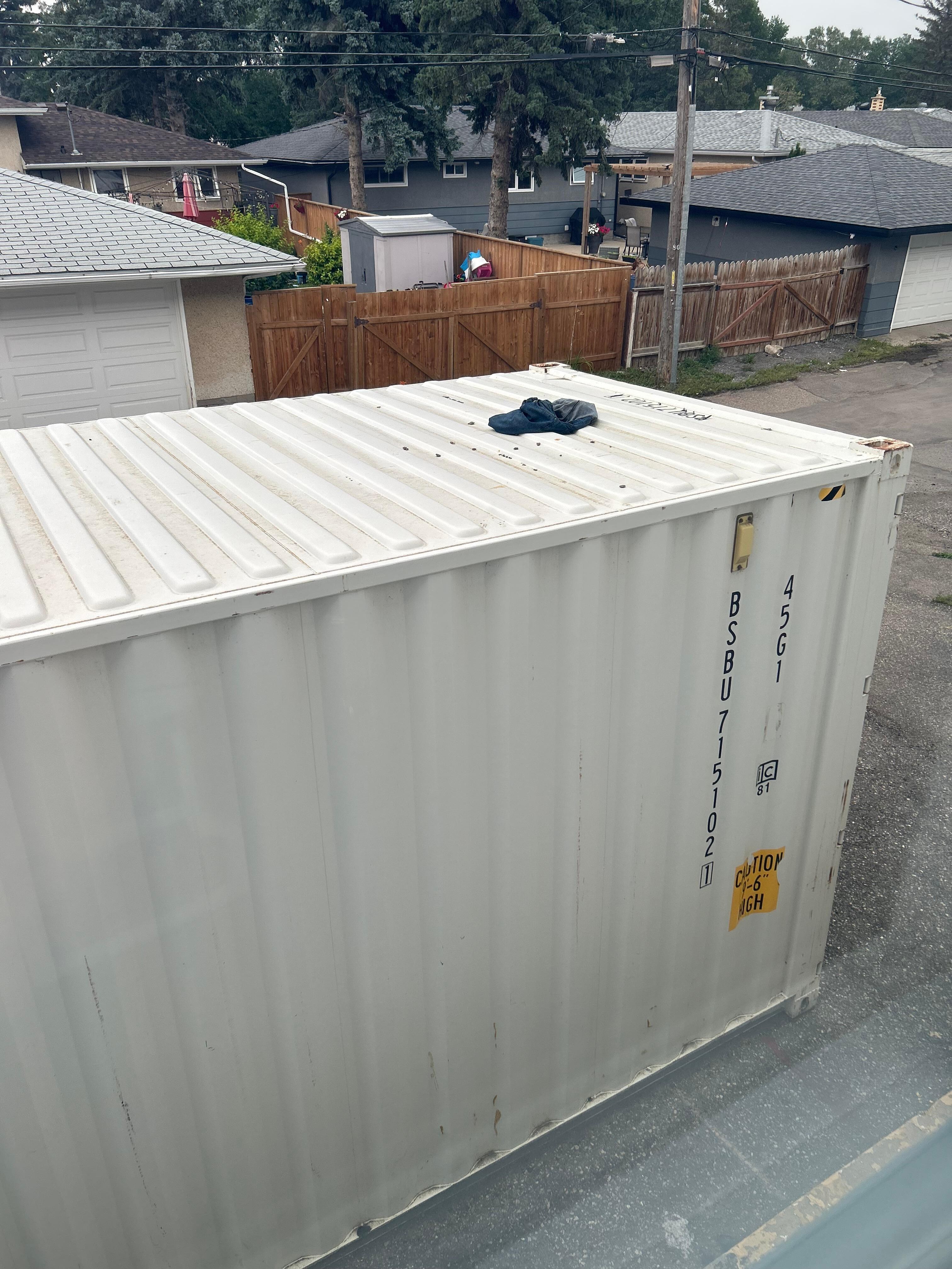 Dirty jeans thrown on container (view from room)