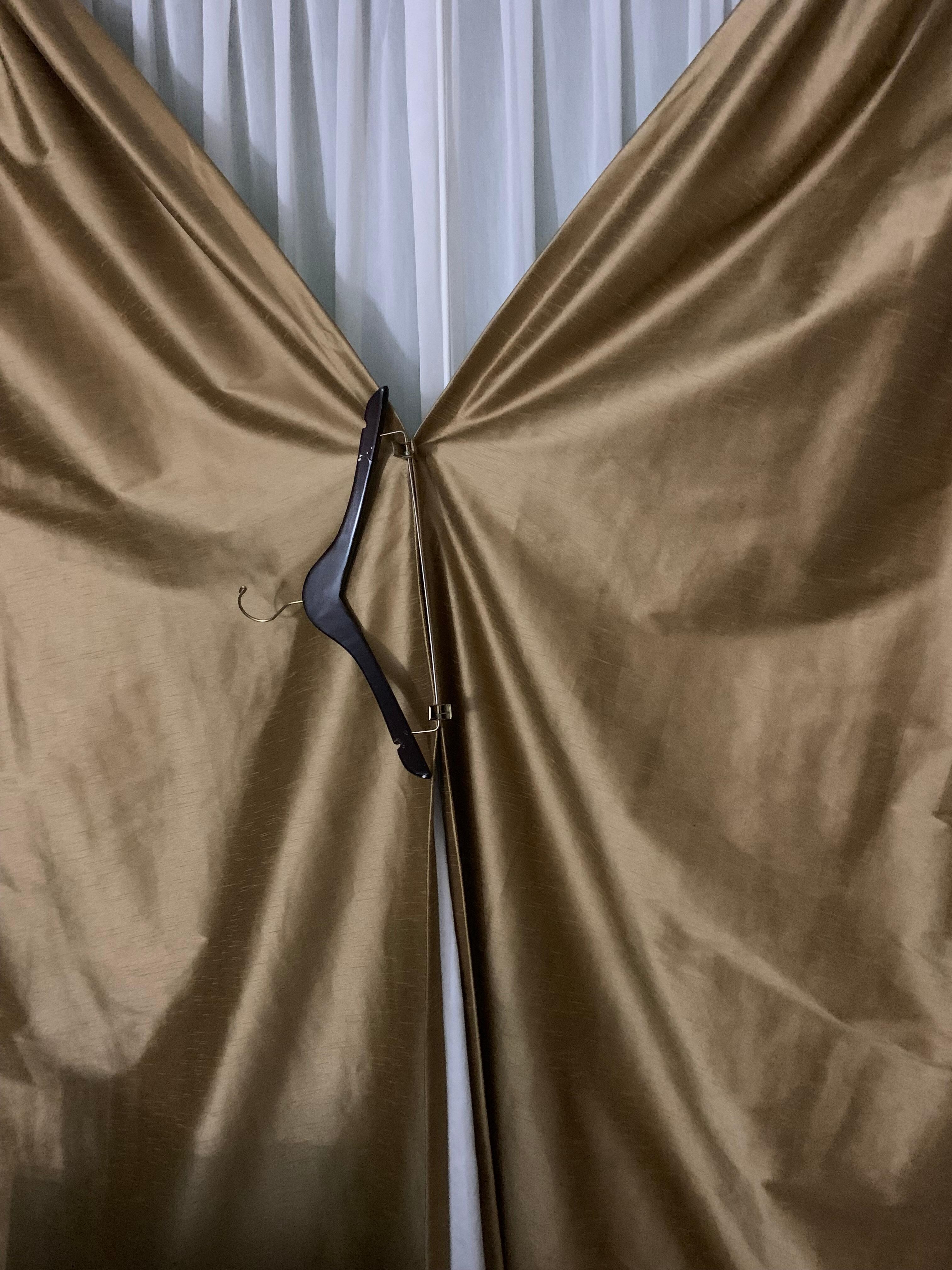 Curtains held together with hanger