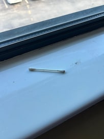 Used q-tip in window