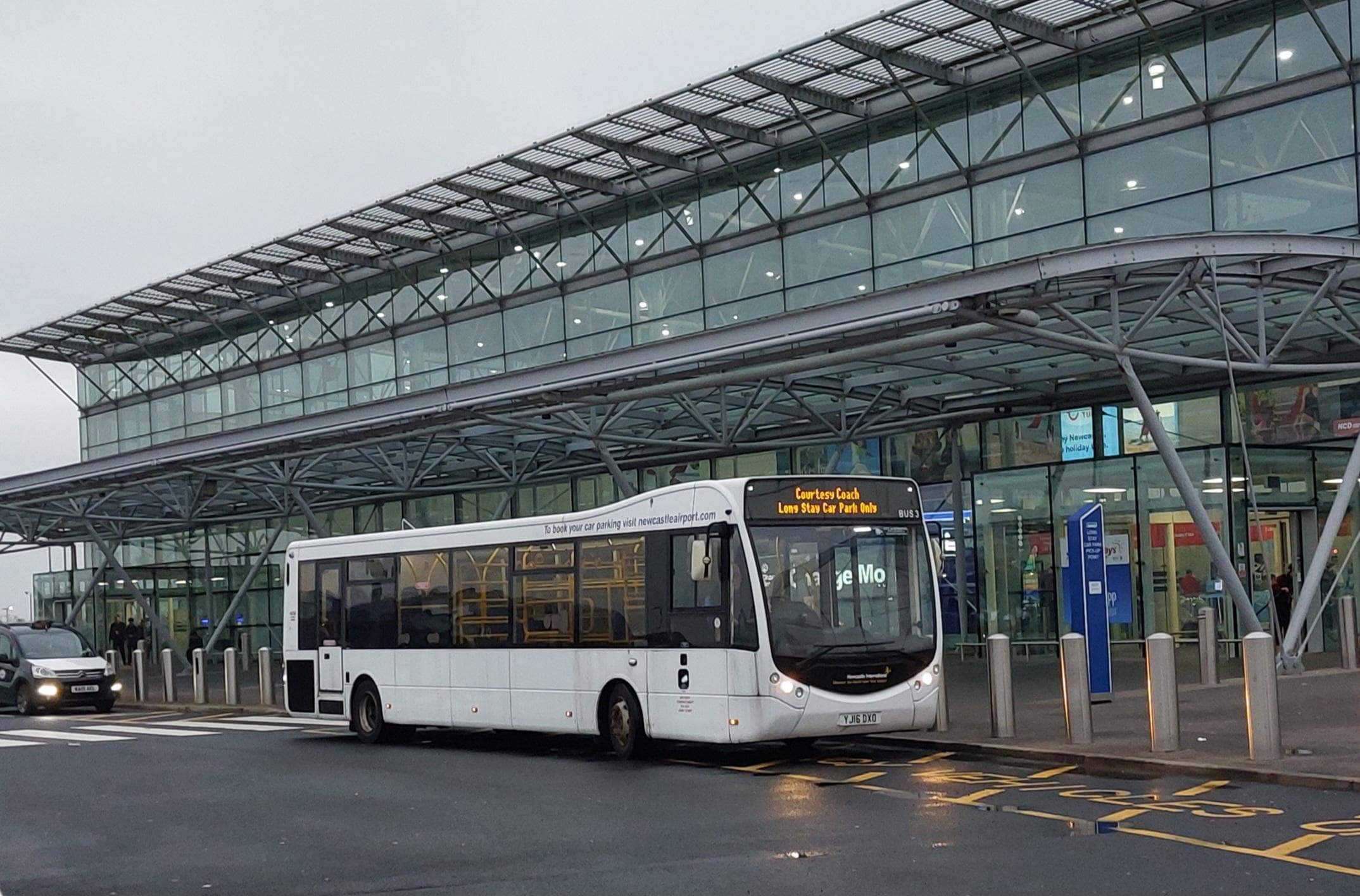 Exterior shot of the airport  and internal bus service/courtesy coach for long-stay carpark. Only 3°C and wet.