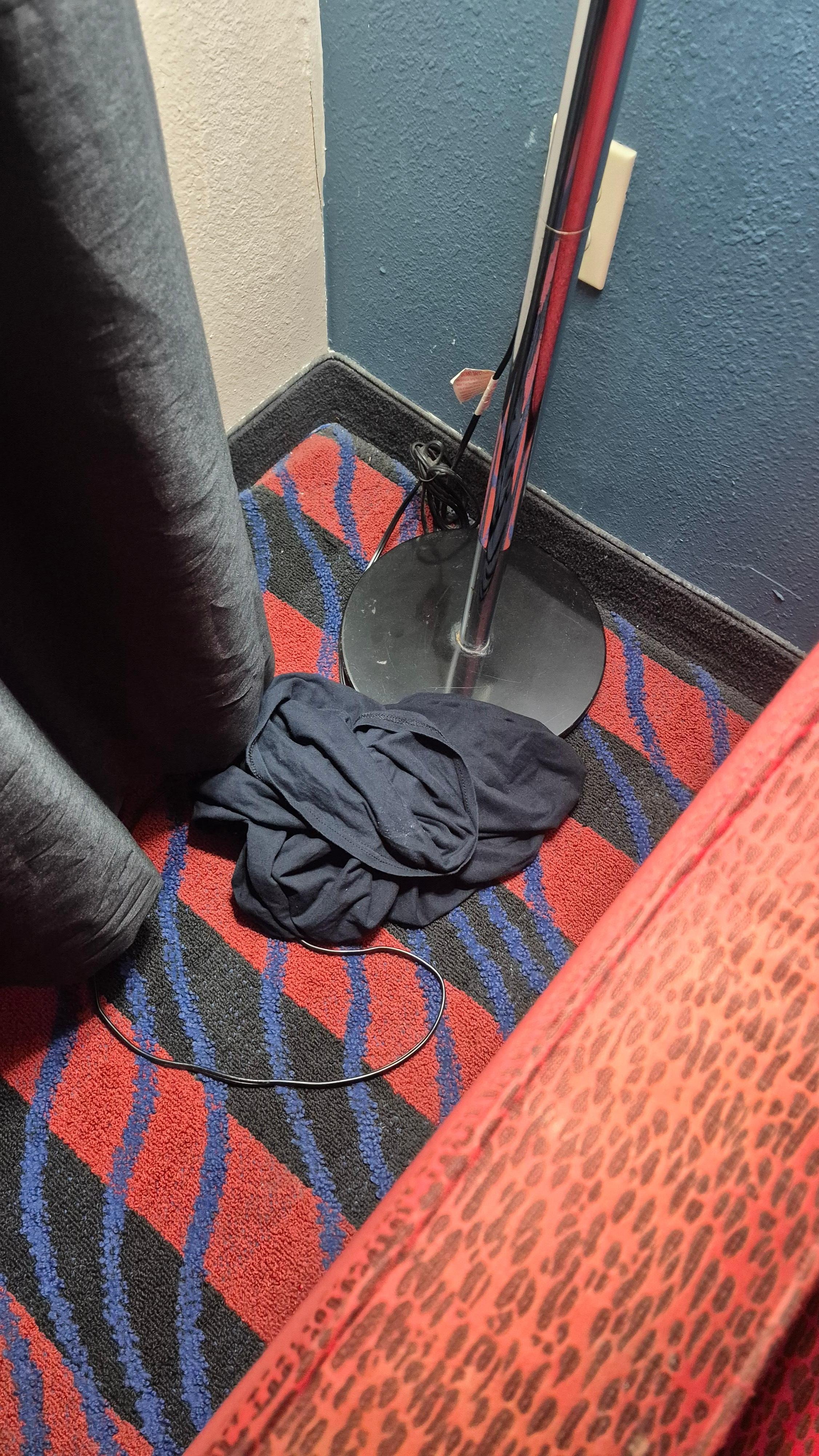Dirty shirt left in corner from a previous guest.