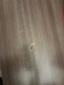 Burns/damage on the table of a smokeless room.