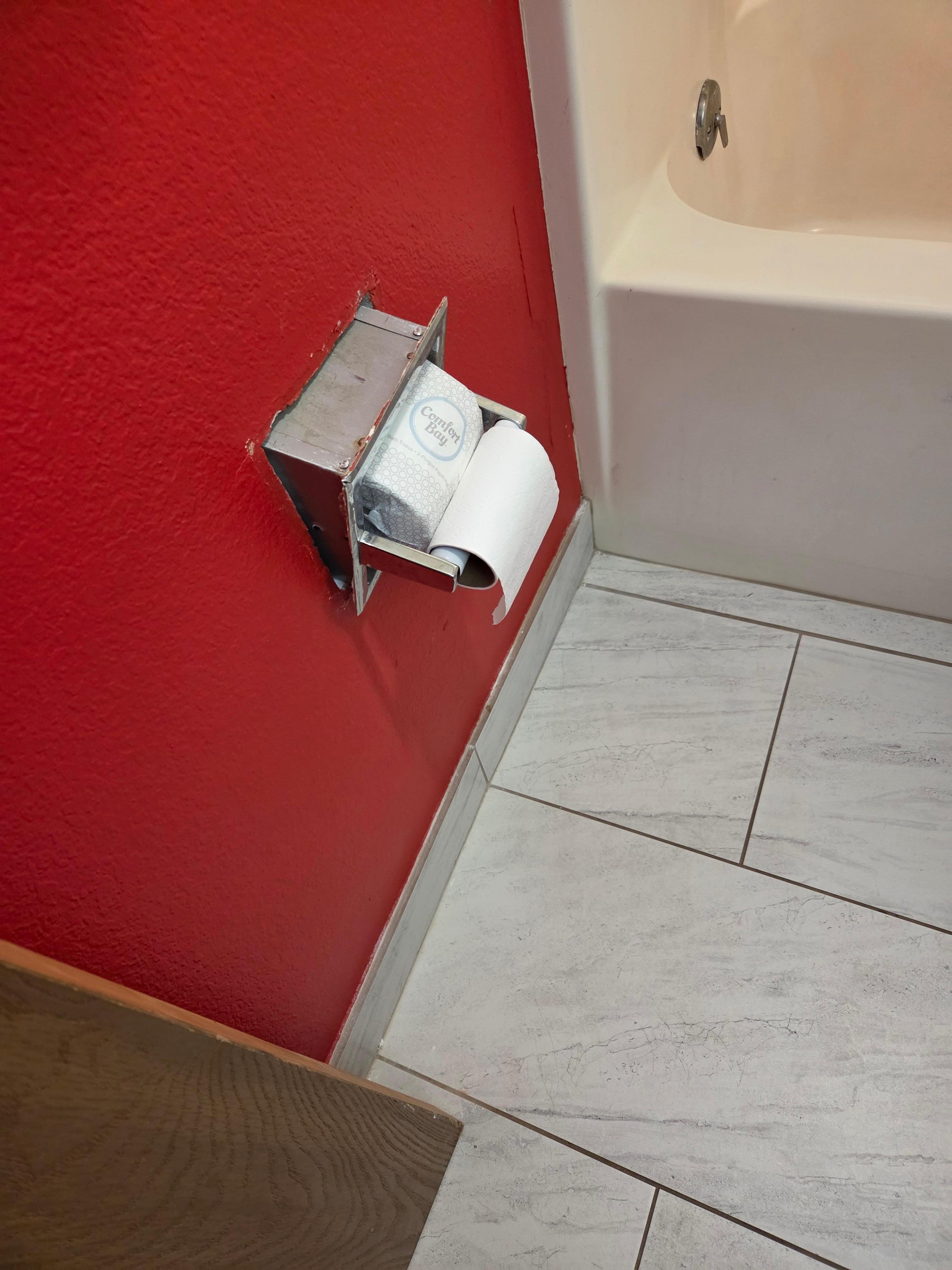 Went into the bathroom found the t paper holder like this. Tub and sink had hair left in it. Also a wash cloth on the sink dirty.