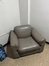 The absolutely disgusting couch that had crumbs and debris in the cracks, and damage on the arm.