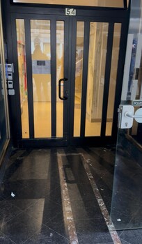 Uninviting entrance, down an alley between two shops.