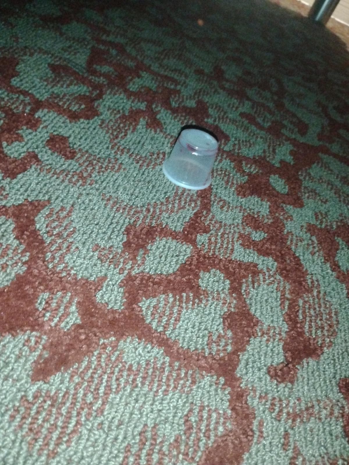 Childs medicine used cup under the bed with trash