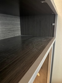 Open closet with housekeeper only dusted half of it.