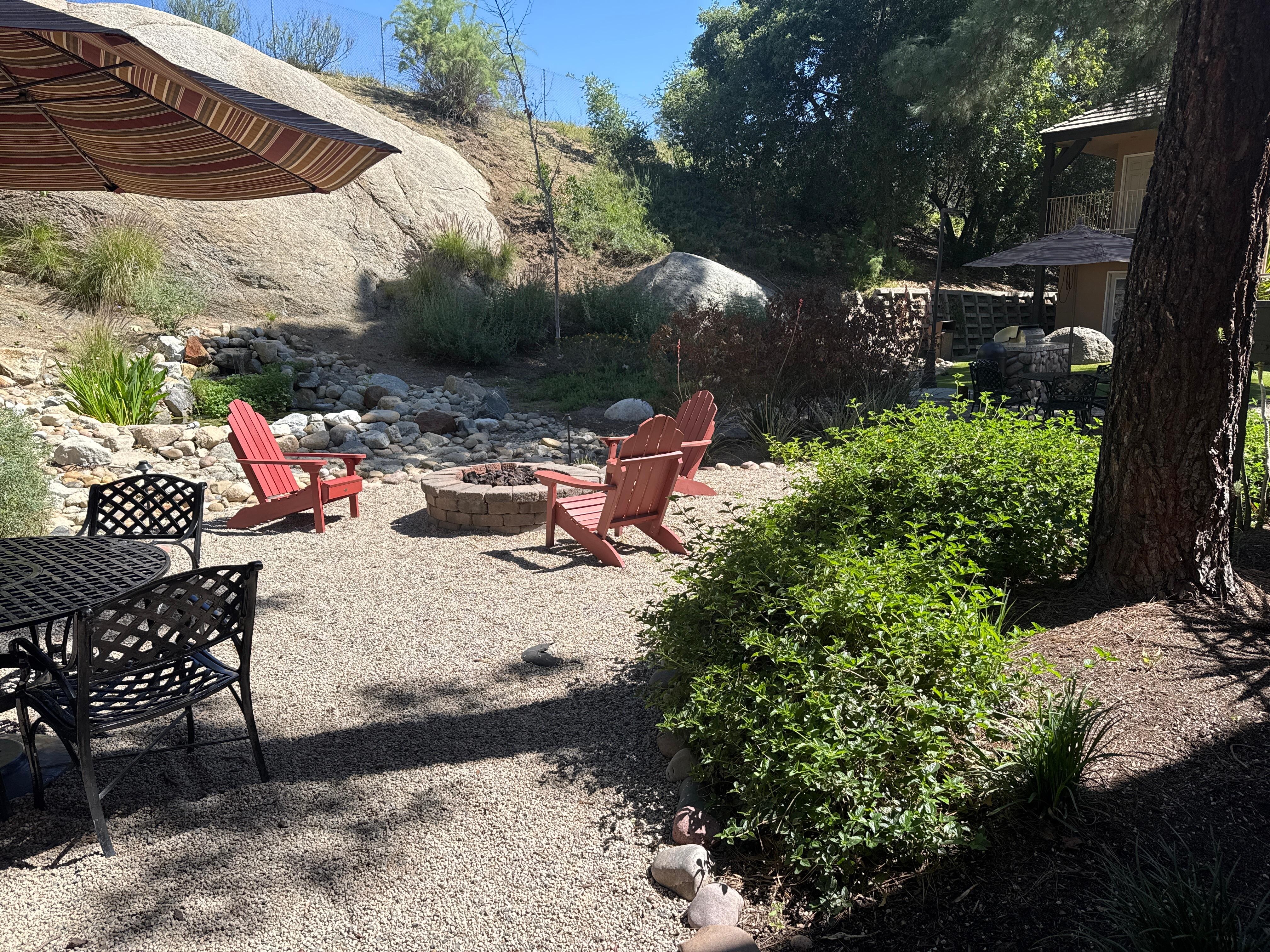 Sitting area behind the hotel. BBQ & tables for eating outside. 