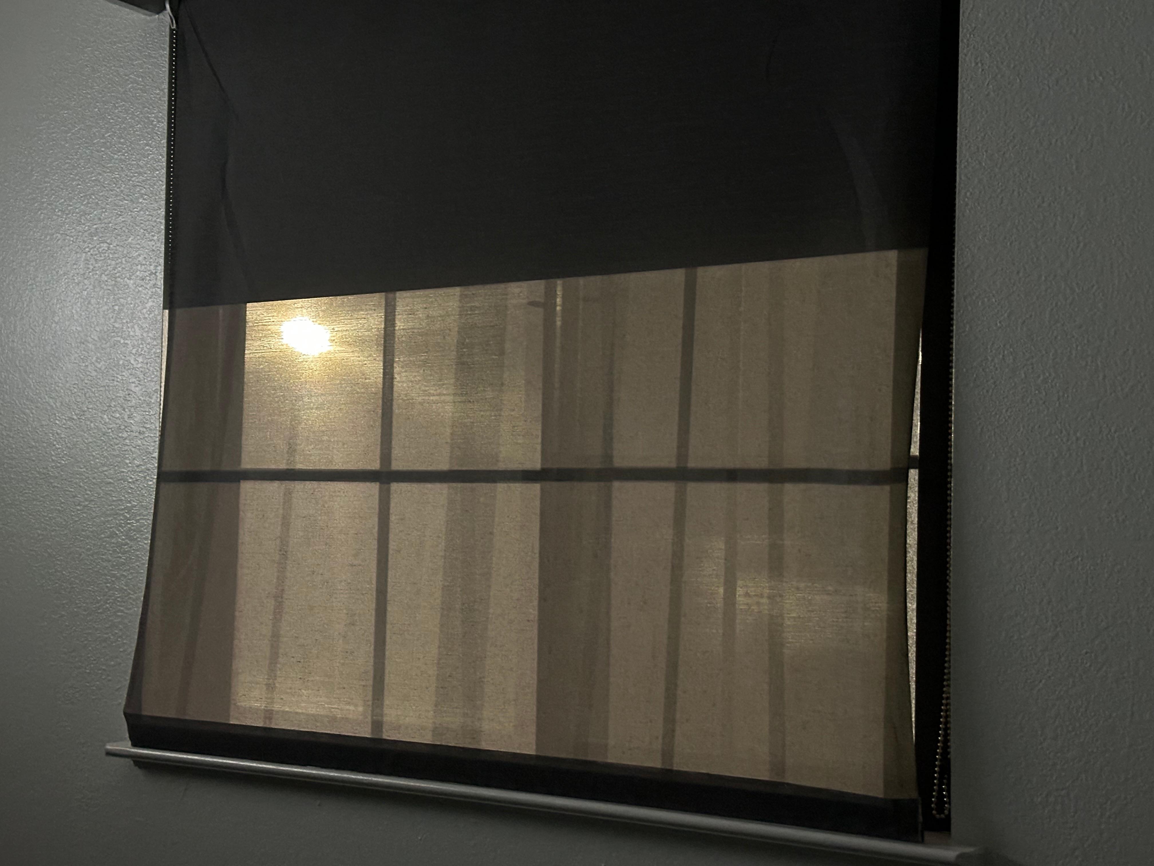 View of the parking lot light from the bed-the shade only blacks out this far