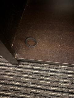 Hair tie under cabinet.
