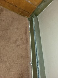 The baseboard and floor outside our door