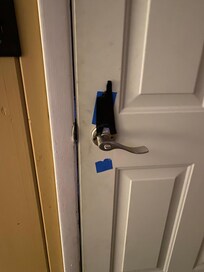 Hole in entry door covered with tape