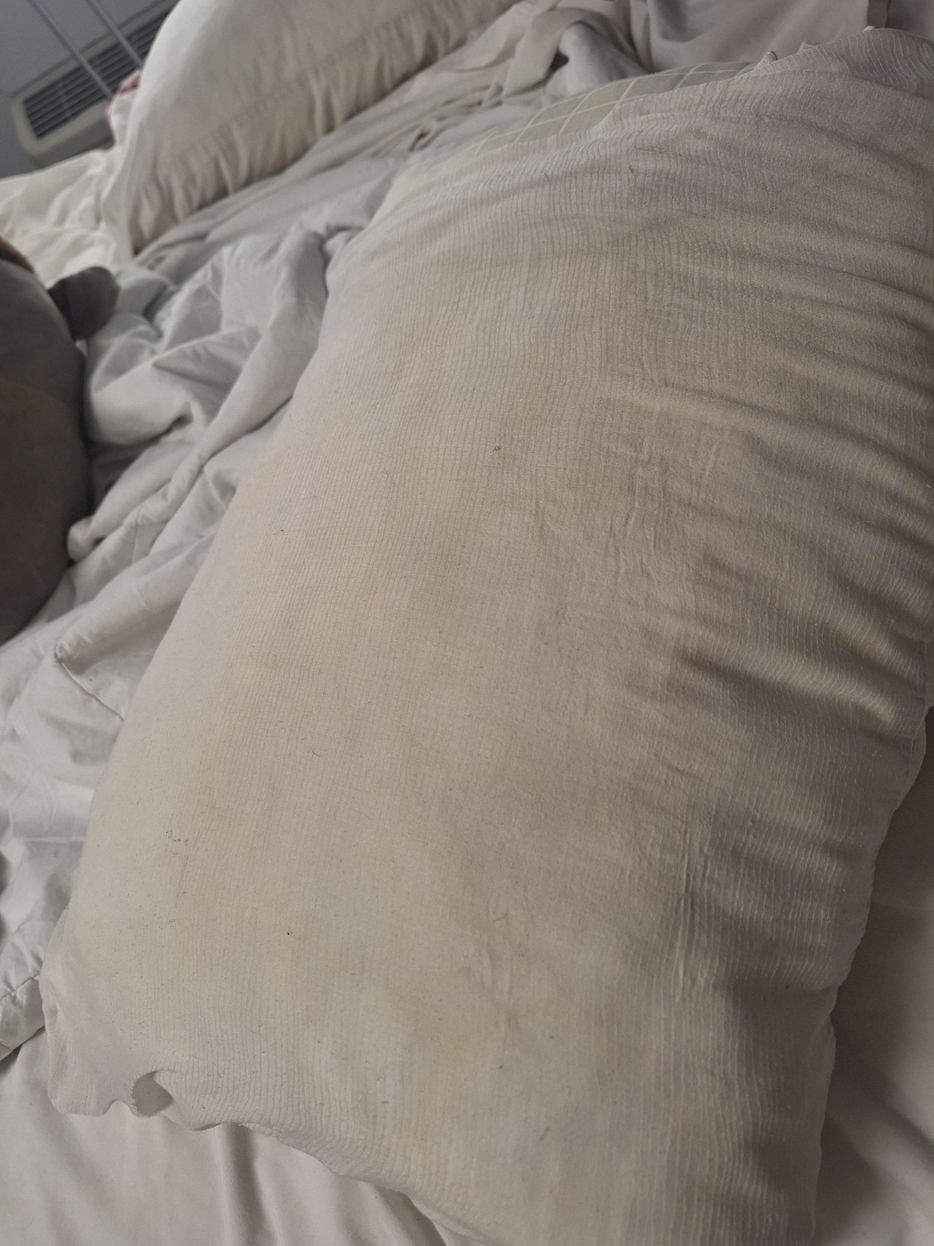 Very thin yellow stained pillow cases.