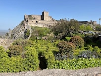 Marvão Castle, preceded by a lovely garden with rosemary and hydrangeas.
