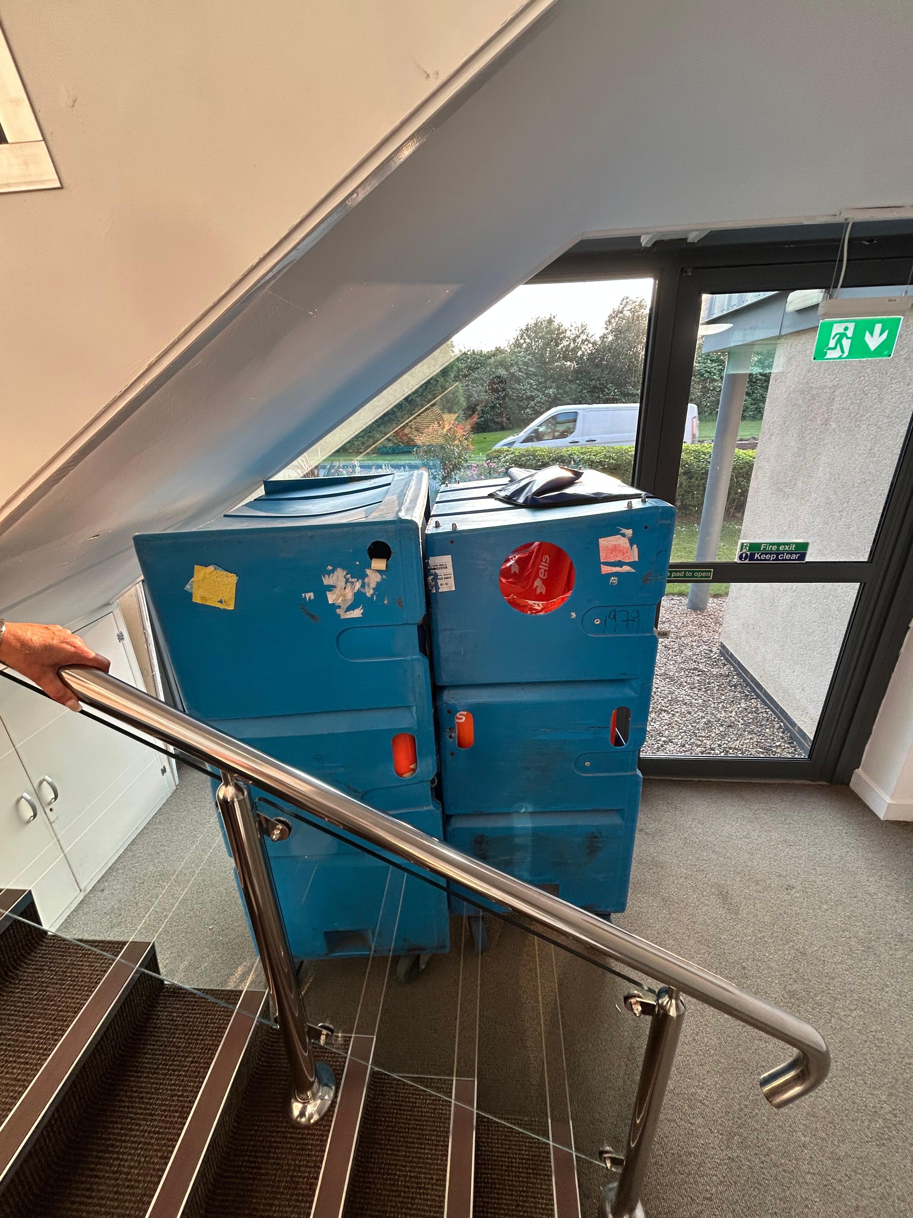 Trolleys in public corridors with dirty washing 