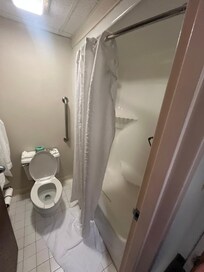 Glass shard/wrapper and hair on bathroom floor