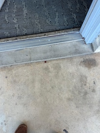 Blood drops on ground outside room