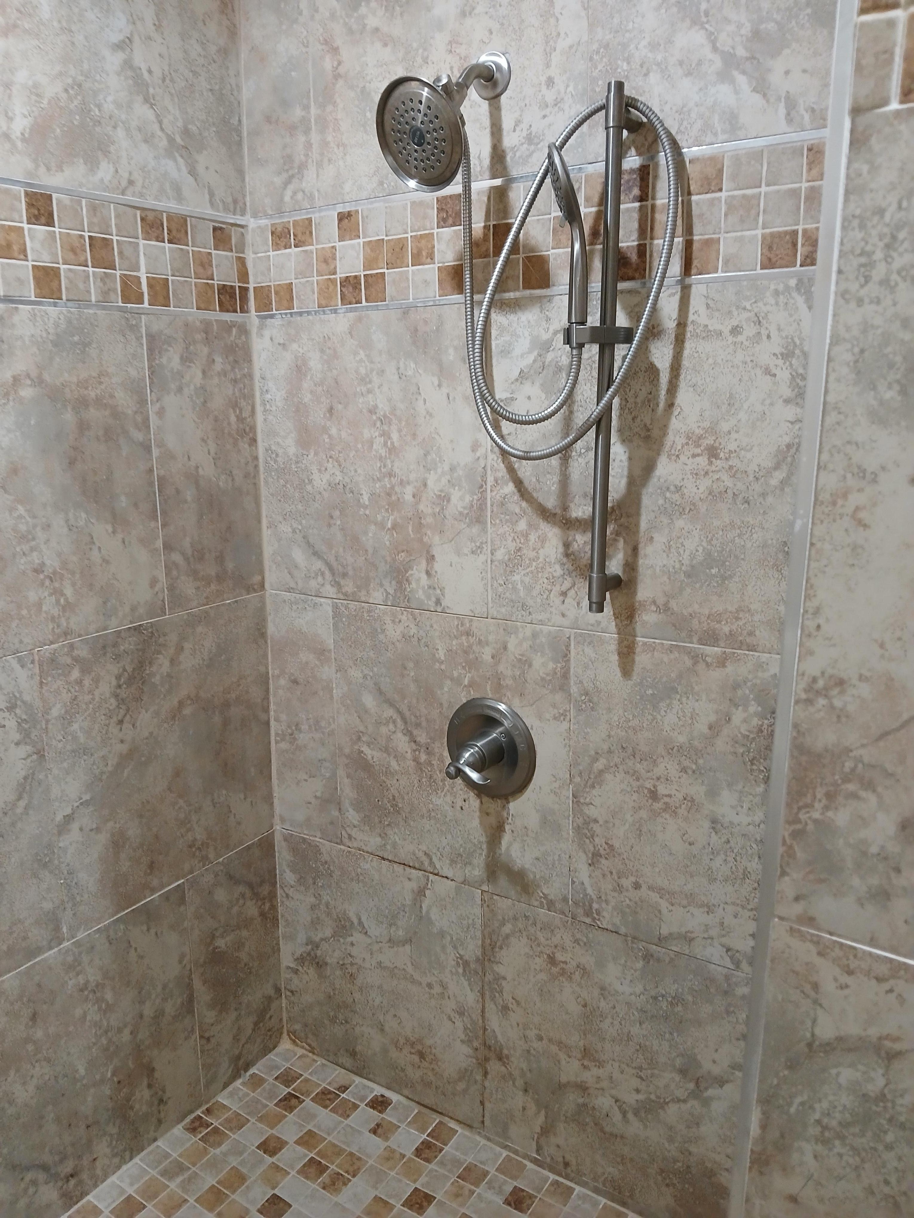 Beautiful large tiled walk in shower, actually nicer than my remodeled shower at home.