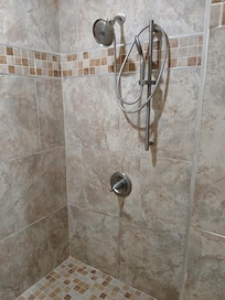 Beautiful large tiled walk in shower, actually nicer than my remodeled shower at home.