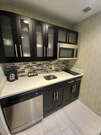 Kitchenette includes a full fridge, stovetop, and dishwasher.