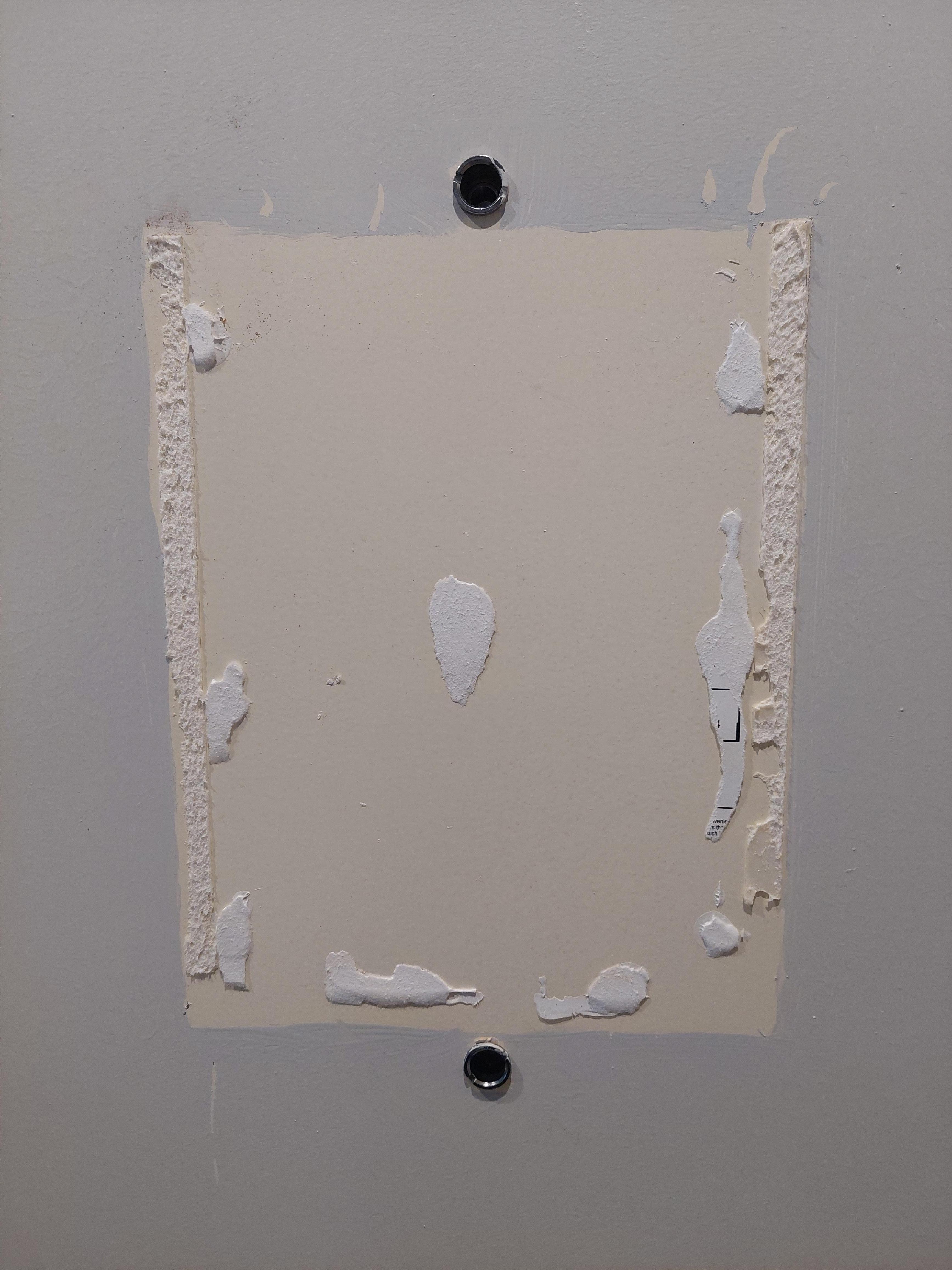 Something ripped off wall and not repainted.