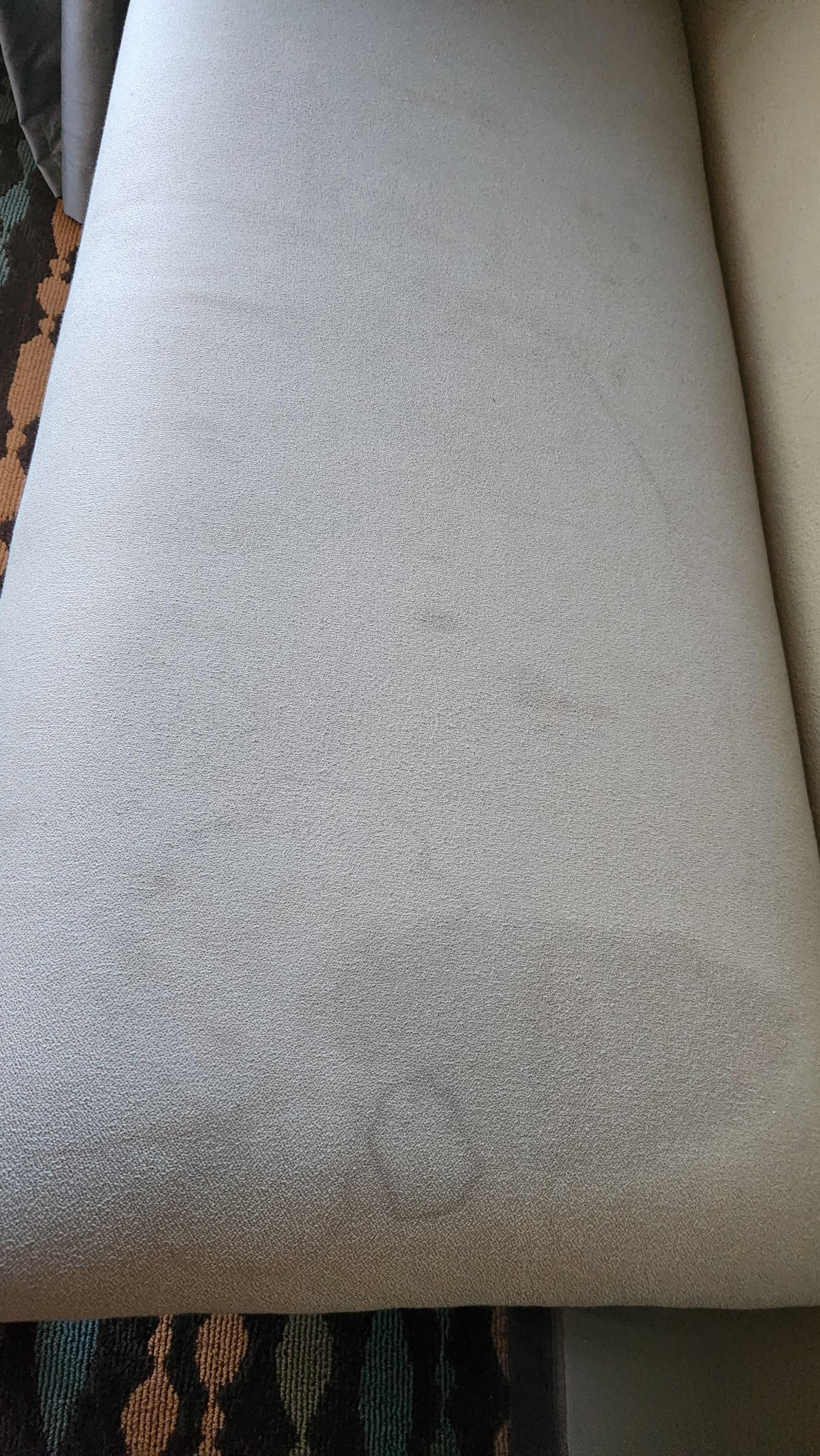 Dingy, stained bench in room