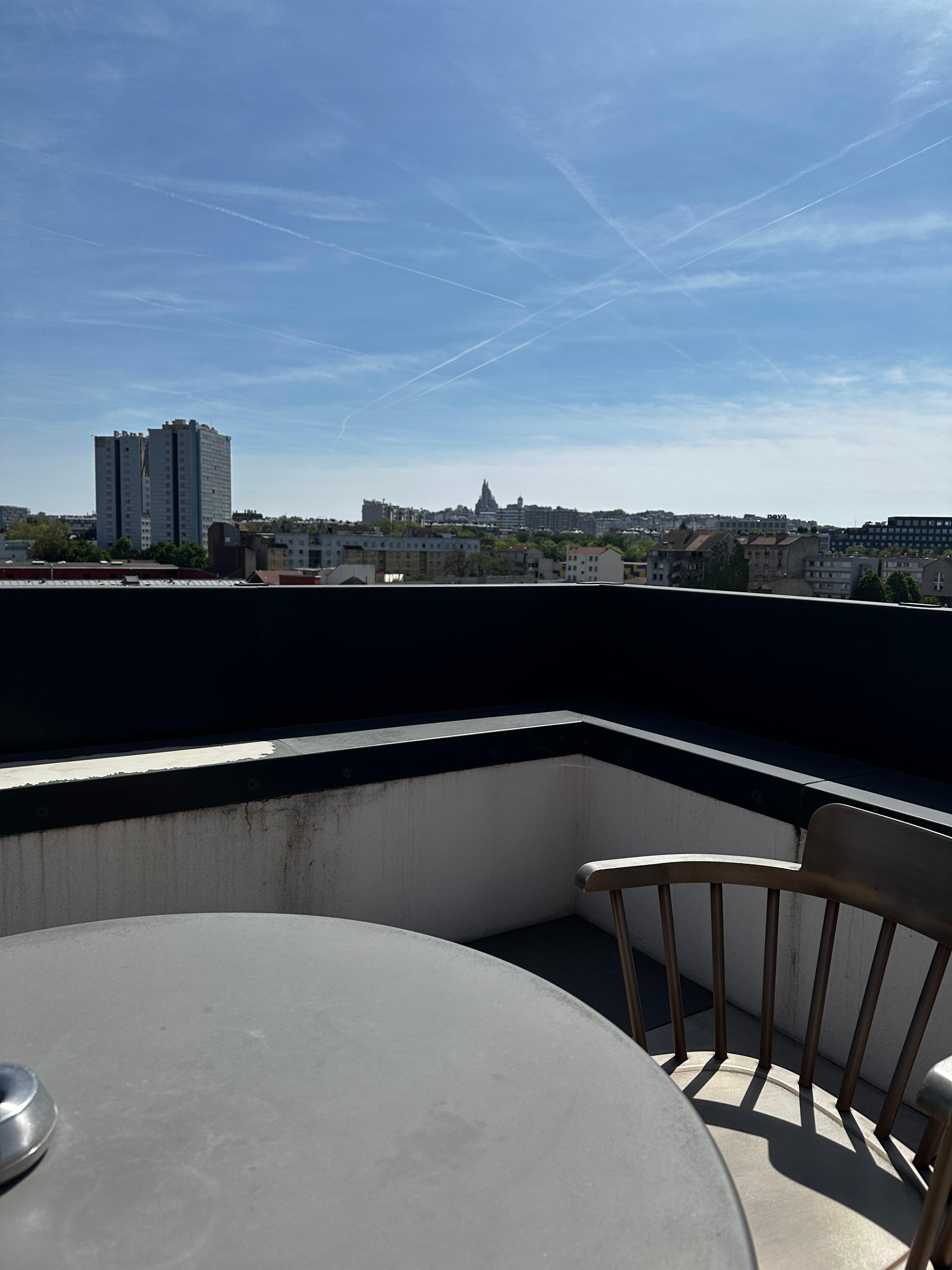 The view from suite terrace shows Sacre Ceur, and strobe light from Eiffel Tower at night