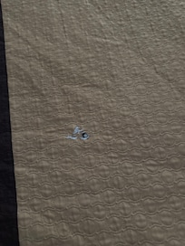 Cigarette burns in the blankets.